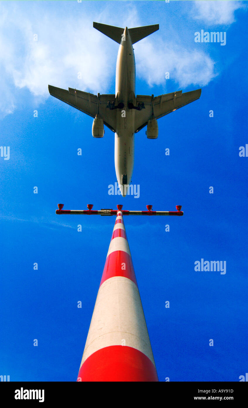 Passenger Plane flying over airport positioning lights Stock Photo - Alamy