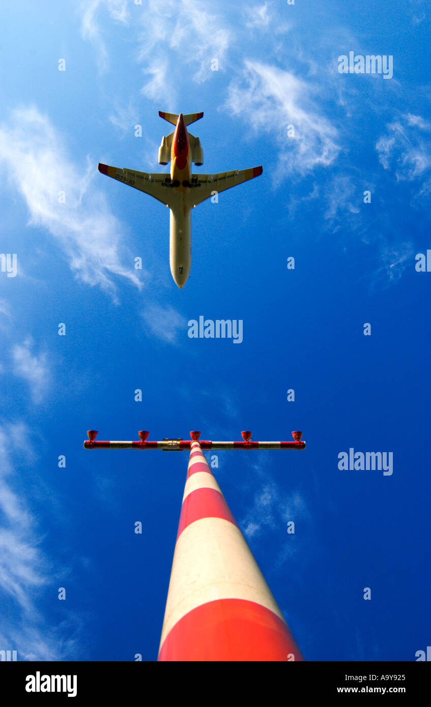 Passenger Plane flying over airport positioning lights Stock Photo - Alamy