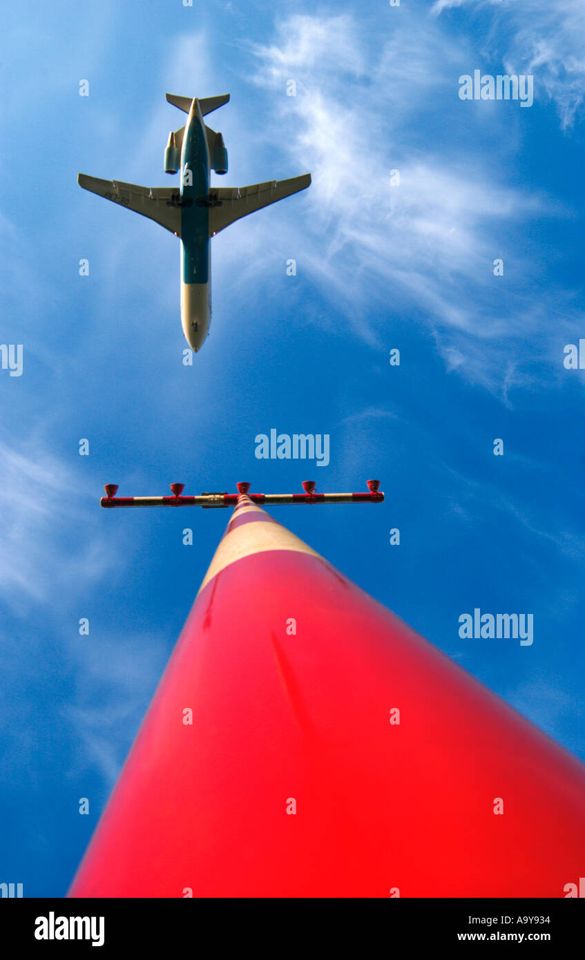 Passenger Plane flying over airport positioning lights Stock Photo - Alamy