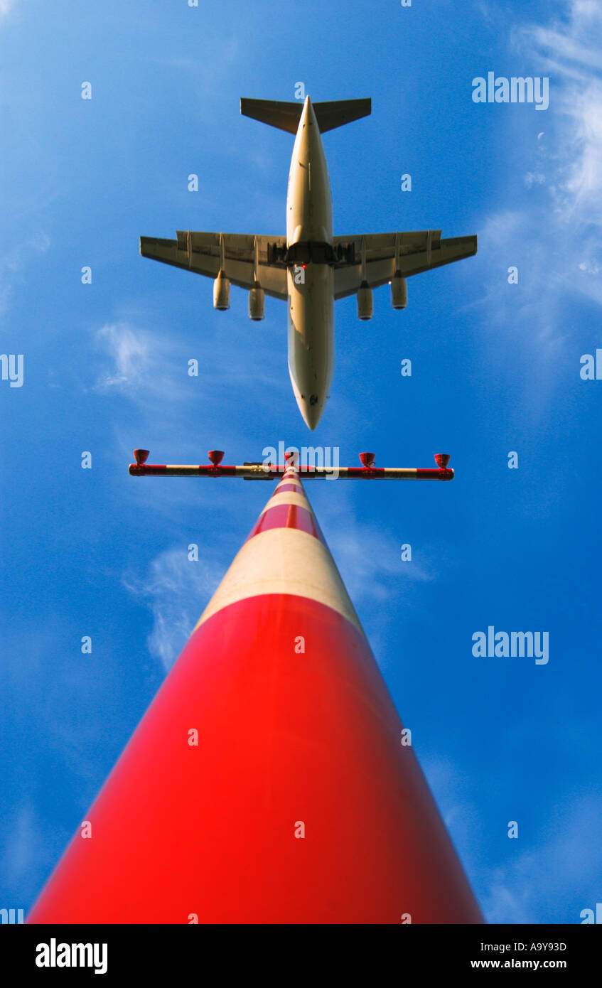 Passenger Plane flying over airport positioning lights Stock Photo - Alamy