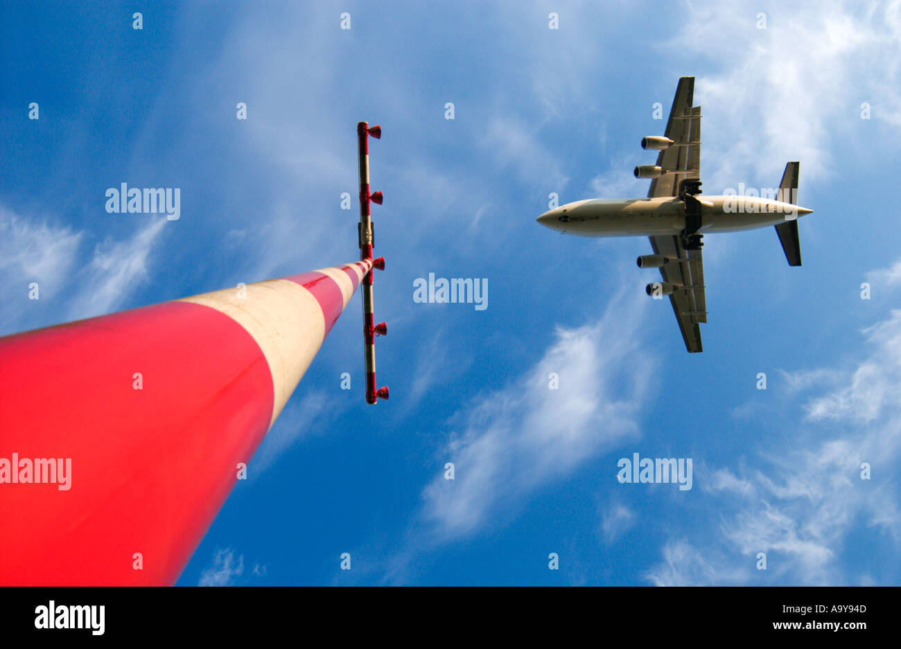 Passenger Plane flying over airport positioning lights Stock Photo - Alamy