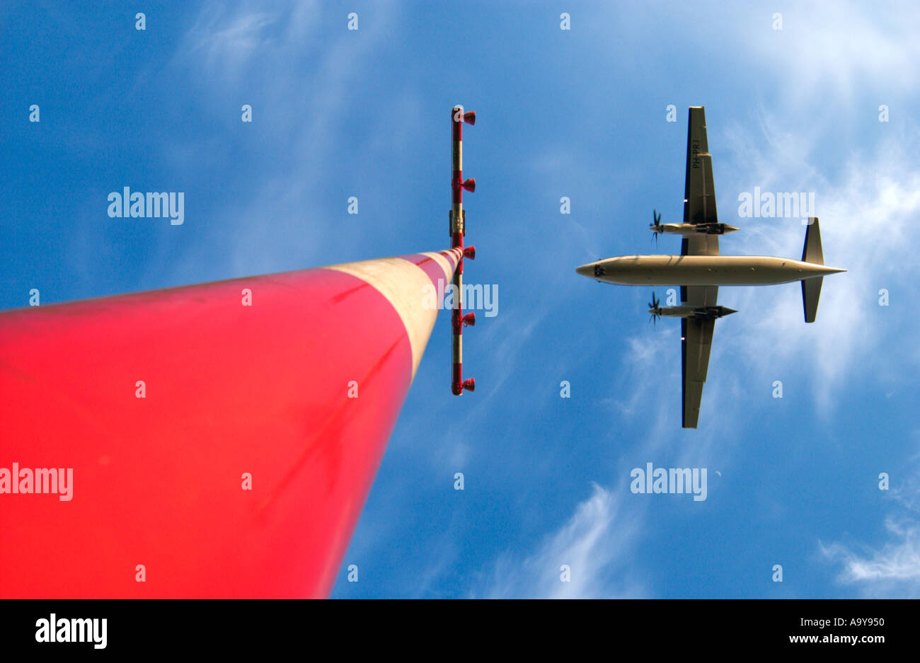 Passenger Plane flying over airport positioning lights Stock Photo - Alamy