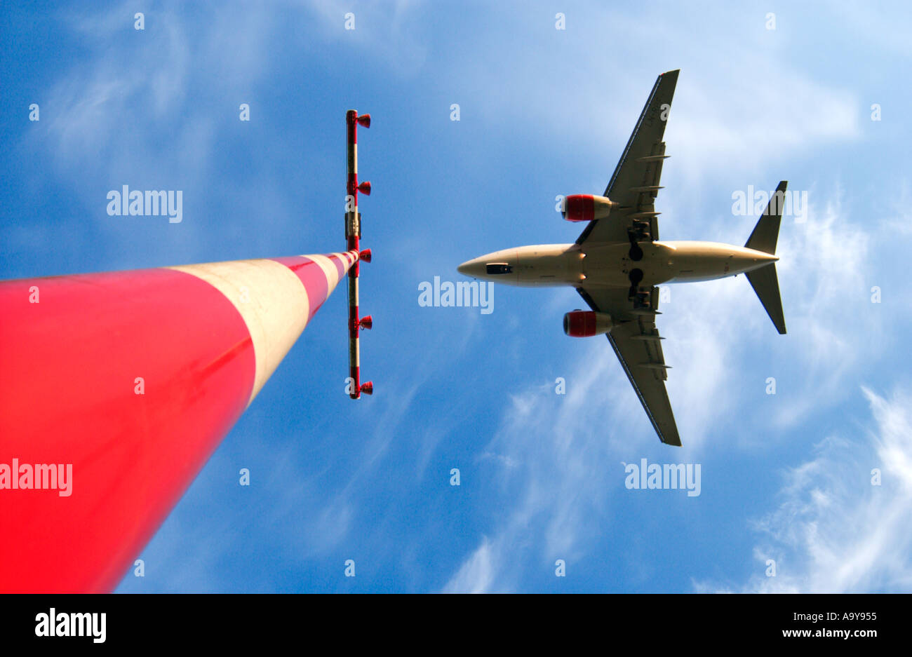 Passenger Plane flying over airport positioning lights Stock Photo - Alamy