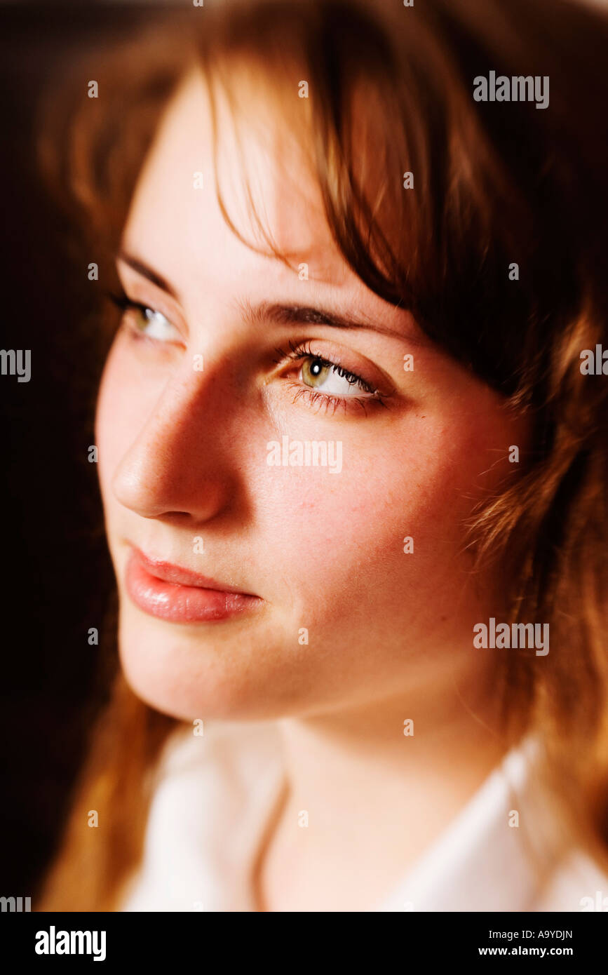 Young woman looking thoughfully Stock Photo - Alamy