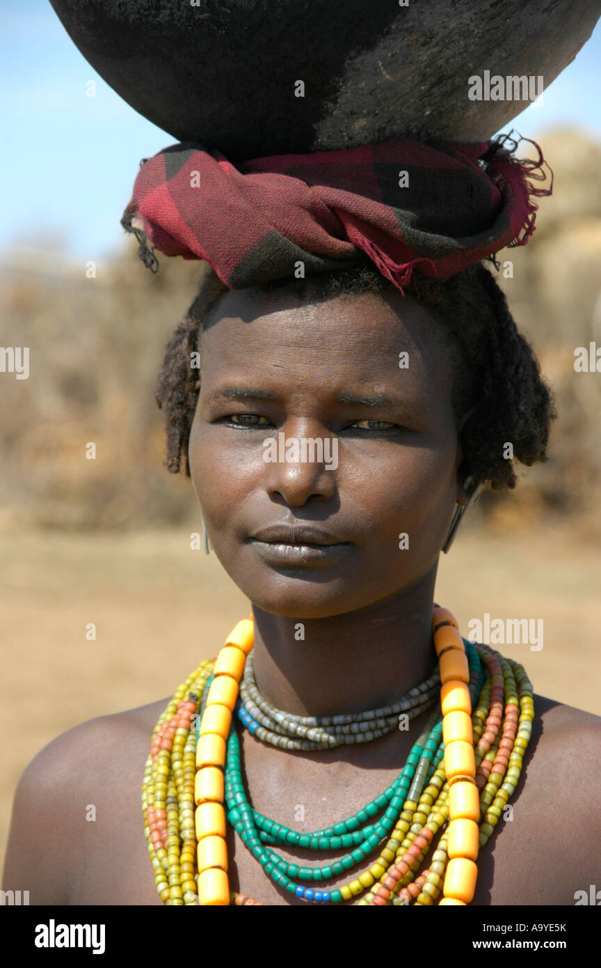 Young woman of the Dassanetch people with a pot on her head Omo River ...