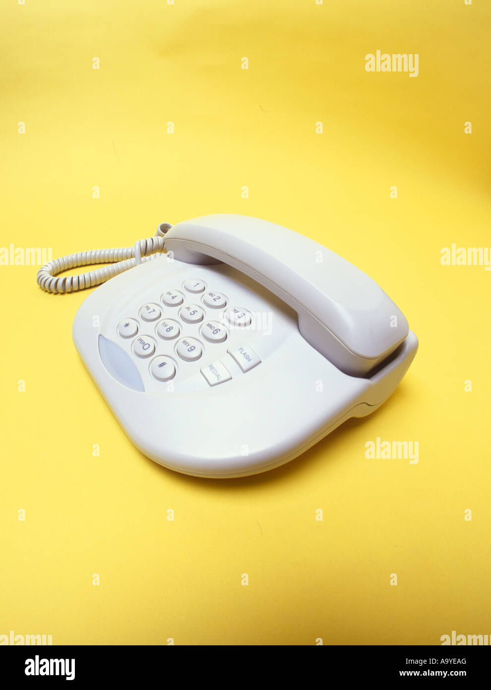 WHITE TELEPHONE ON PLAIN YELLOW BACKGROUND Stock Photo - Alamy