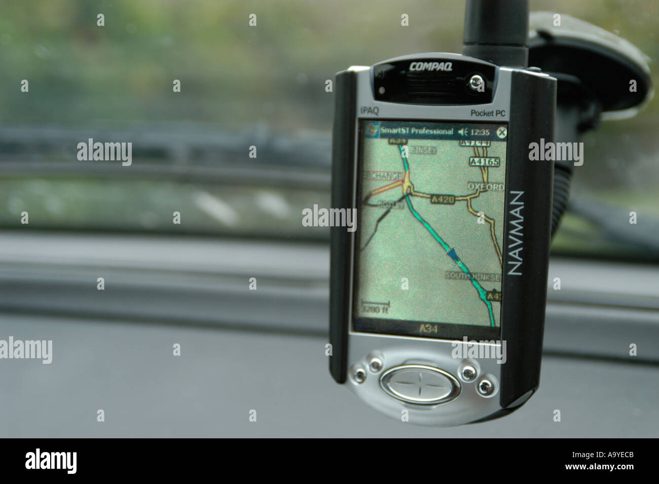 Compac Ipaq pocket PC PDA with navman GPS jacket on screen mount above ...