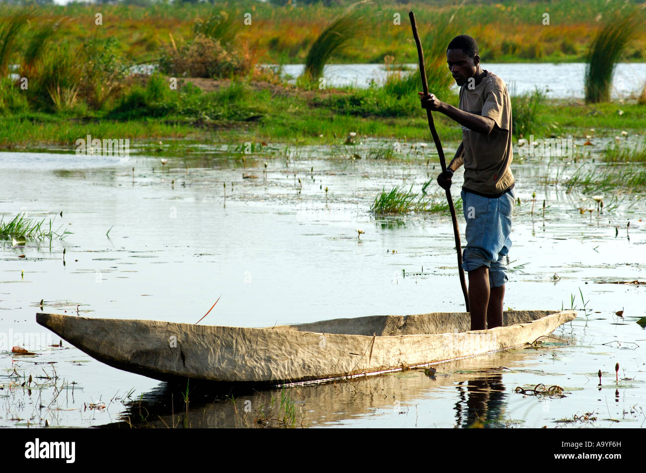 Local Bayei people in the tradiional mokoro dugout boat, Okavango Delta ...