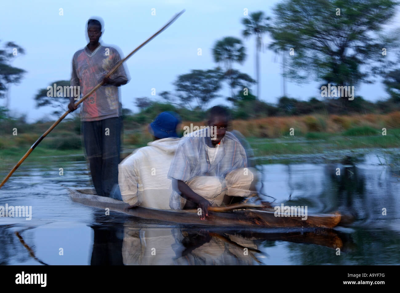Local Bayei people in the tradiional mokoro dugout boat, Okavango Delta ...