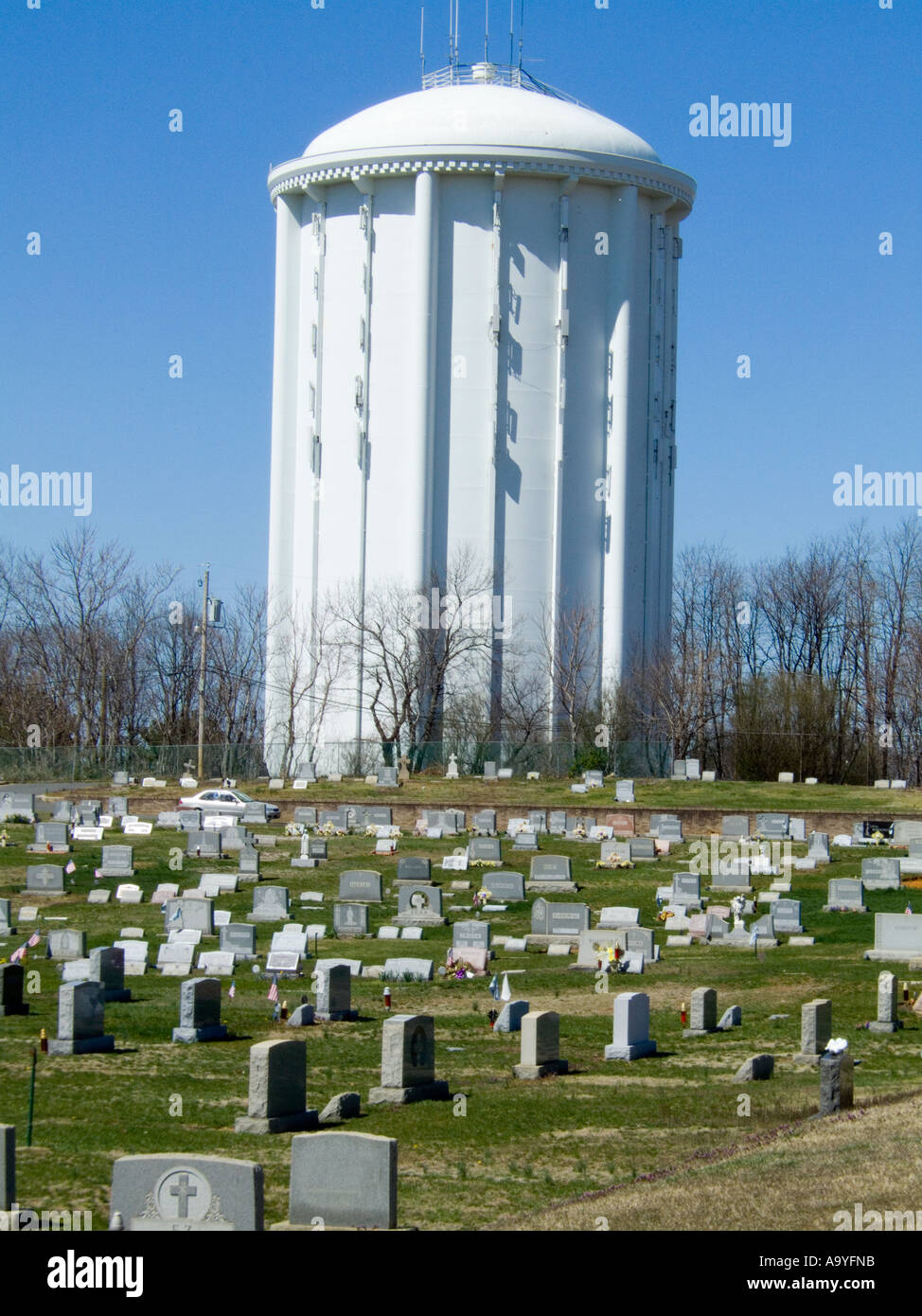 Water tower overlooking a cemetery Stock Photo - Alamy