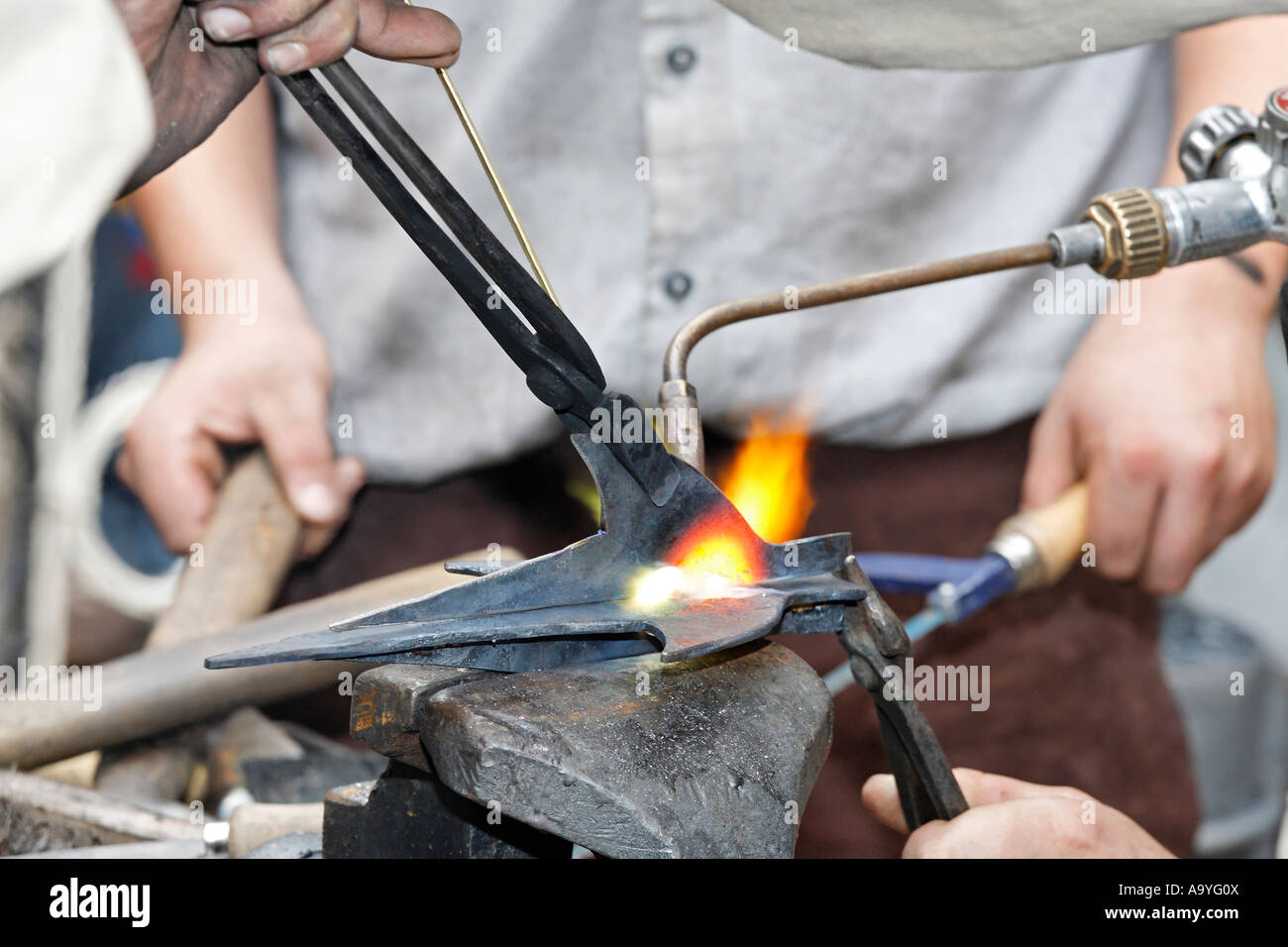 Young locksmith apprentices welding a metal workpiece Stock Photo - Alamy