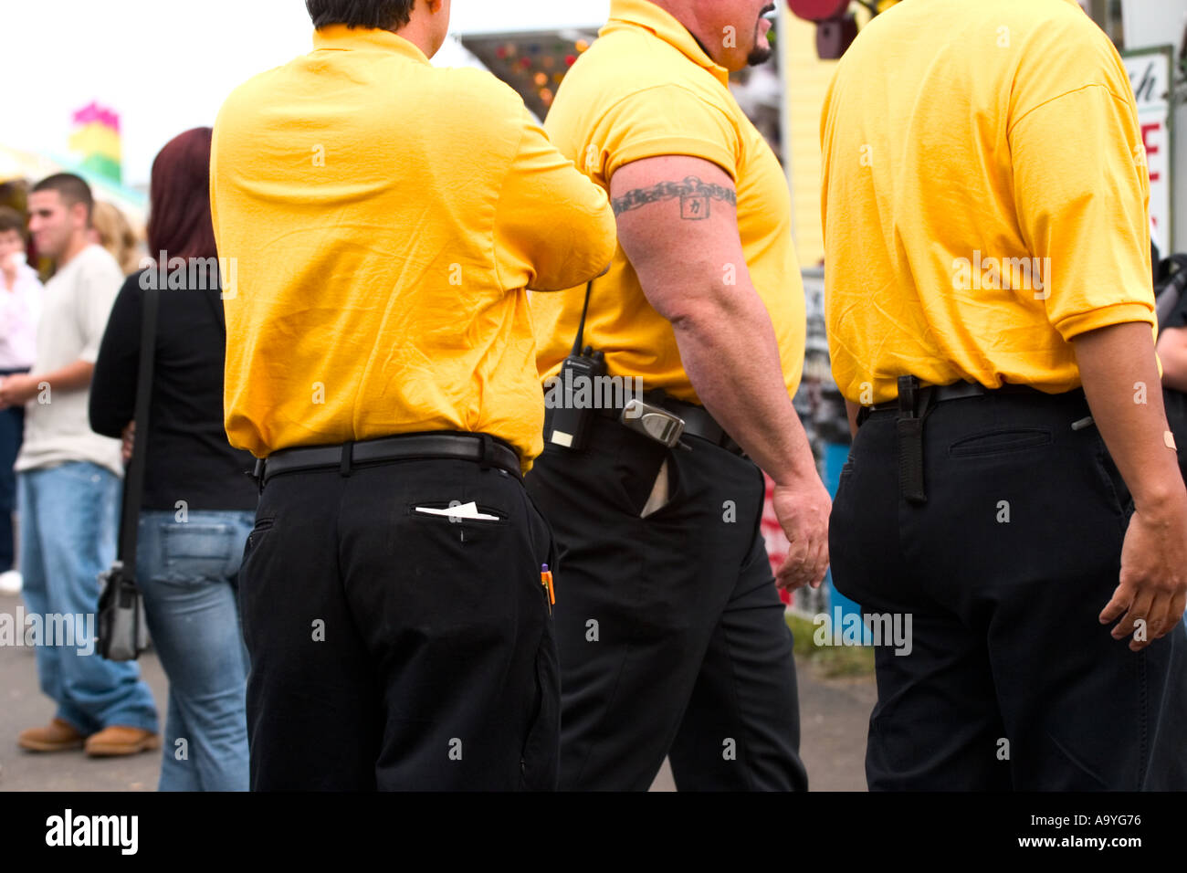 Security people patrolling at a fair Stock Photo - Alamy