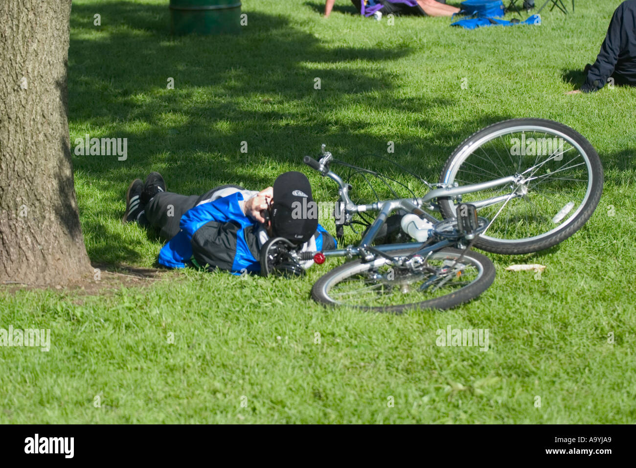 Bicycle laying on the ground with its owner lying next to it Stock ...