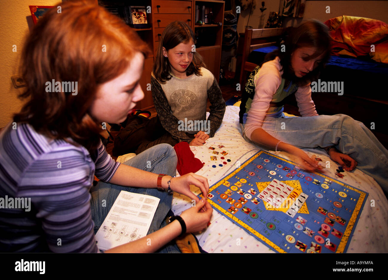 Girls playing a board game, Solingen, North Rhine-Westphalia, Germany ...