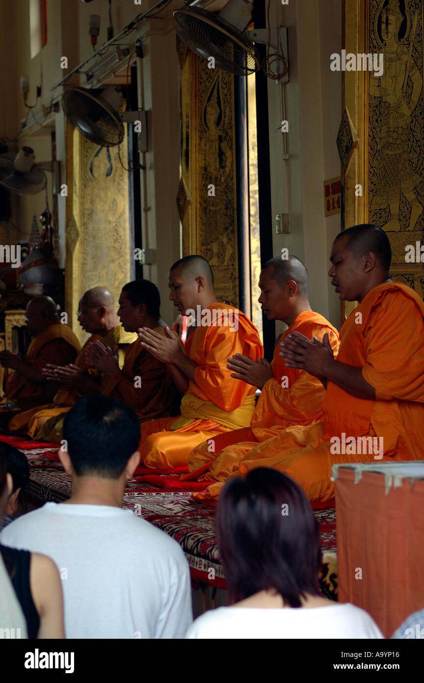 Buddhist monks holding prayers Stock Photo - Alamy