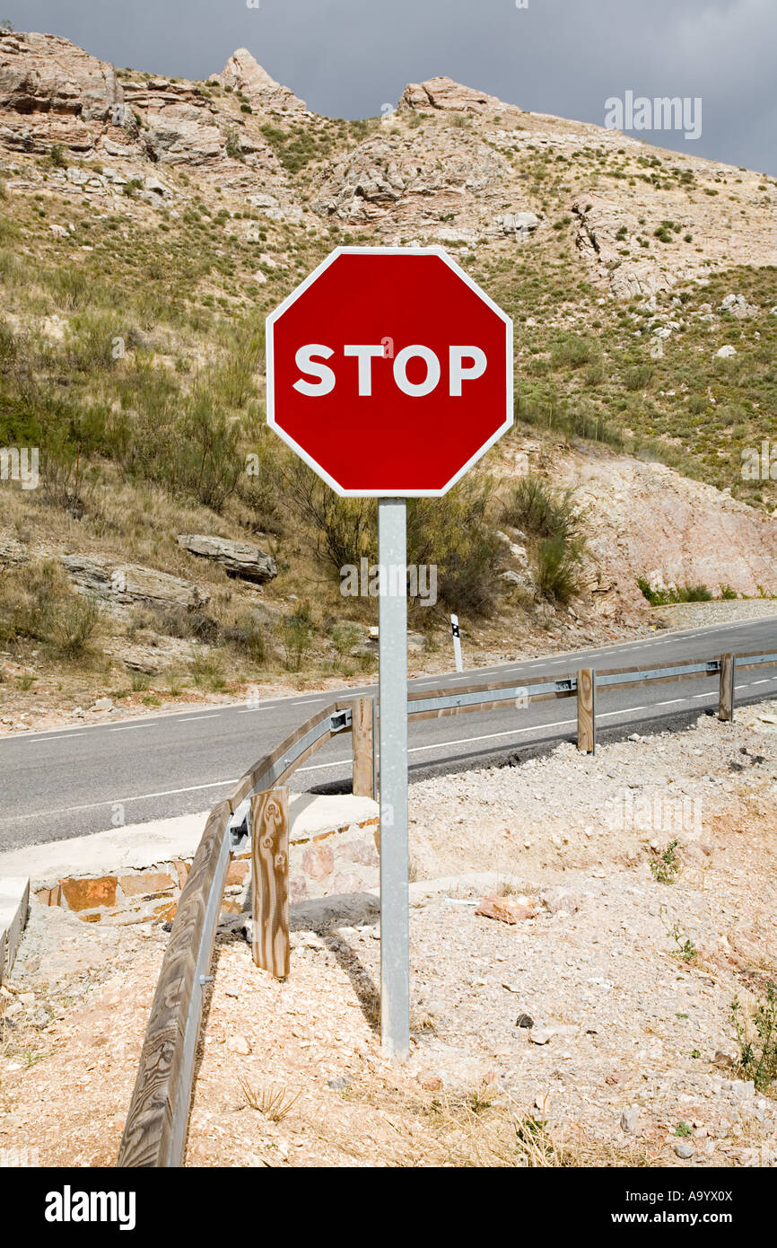 Stop sign near road Stock Photo - Alamy