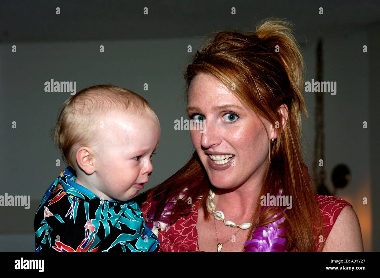 Lady holding crying baby Stock Photo - Alamy
