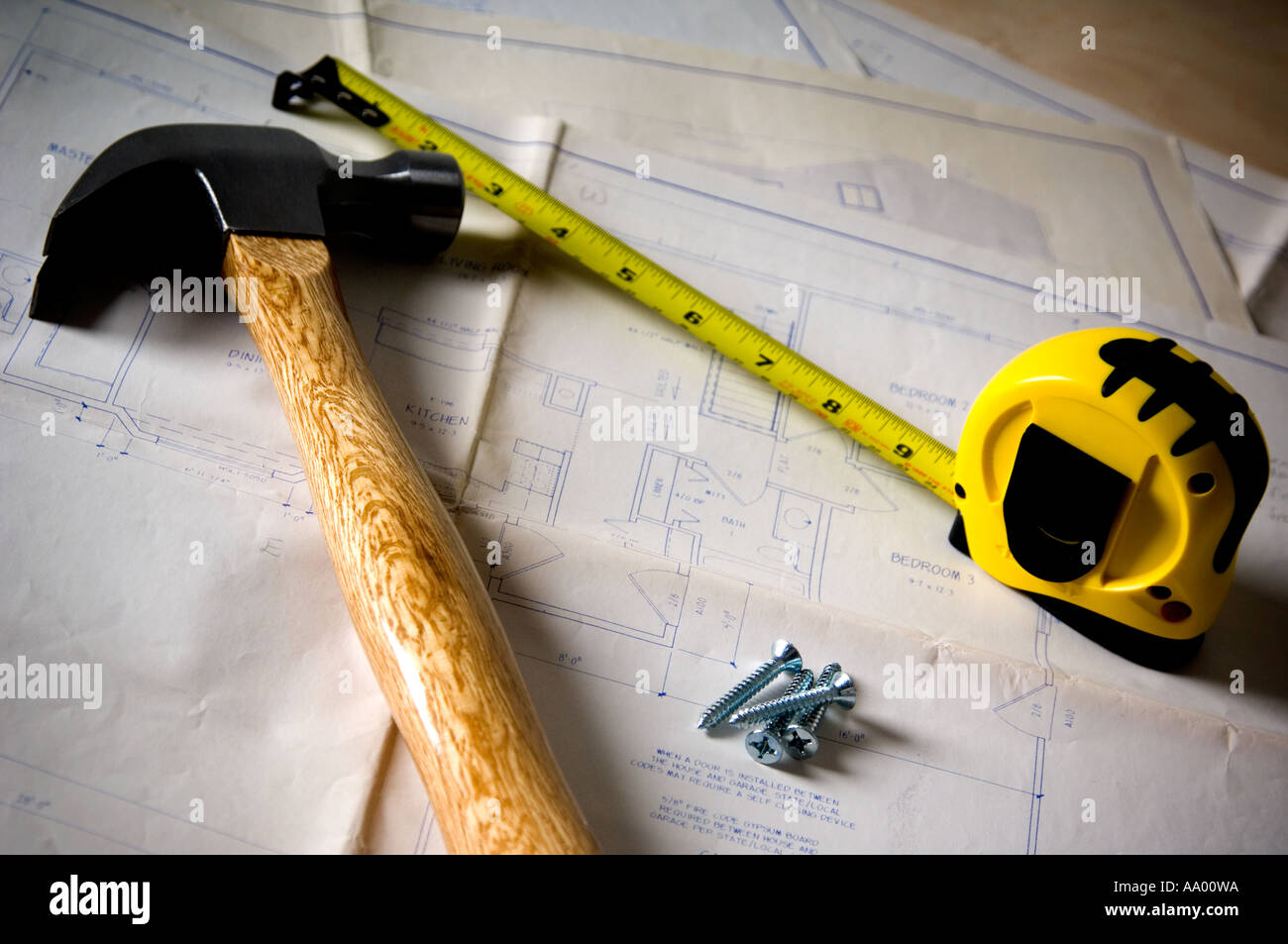 Blueprints tape measure hammer Stock Photo - Alamy