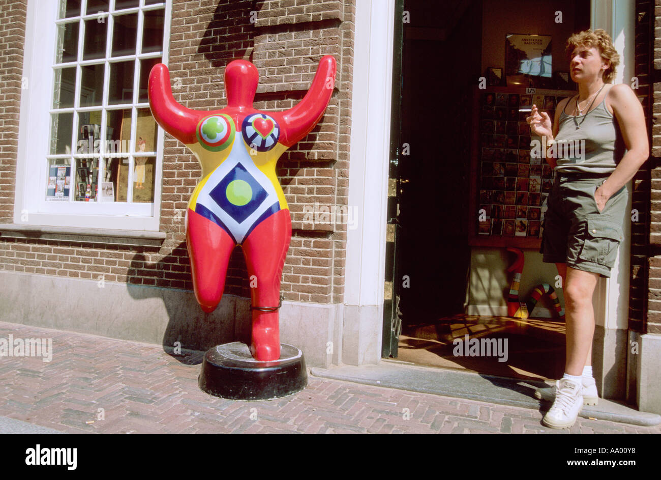 Netherlands, Amsterdam, woman smoking cigarette in front of shop Stock ...