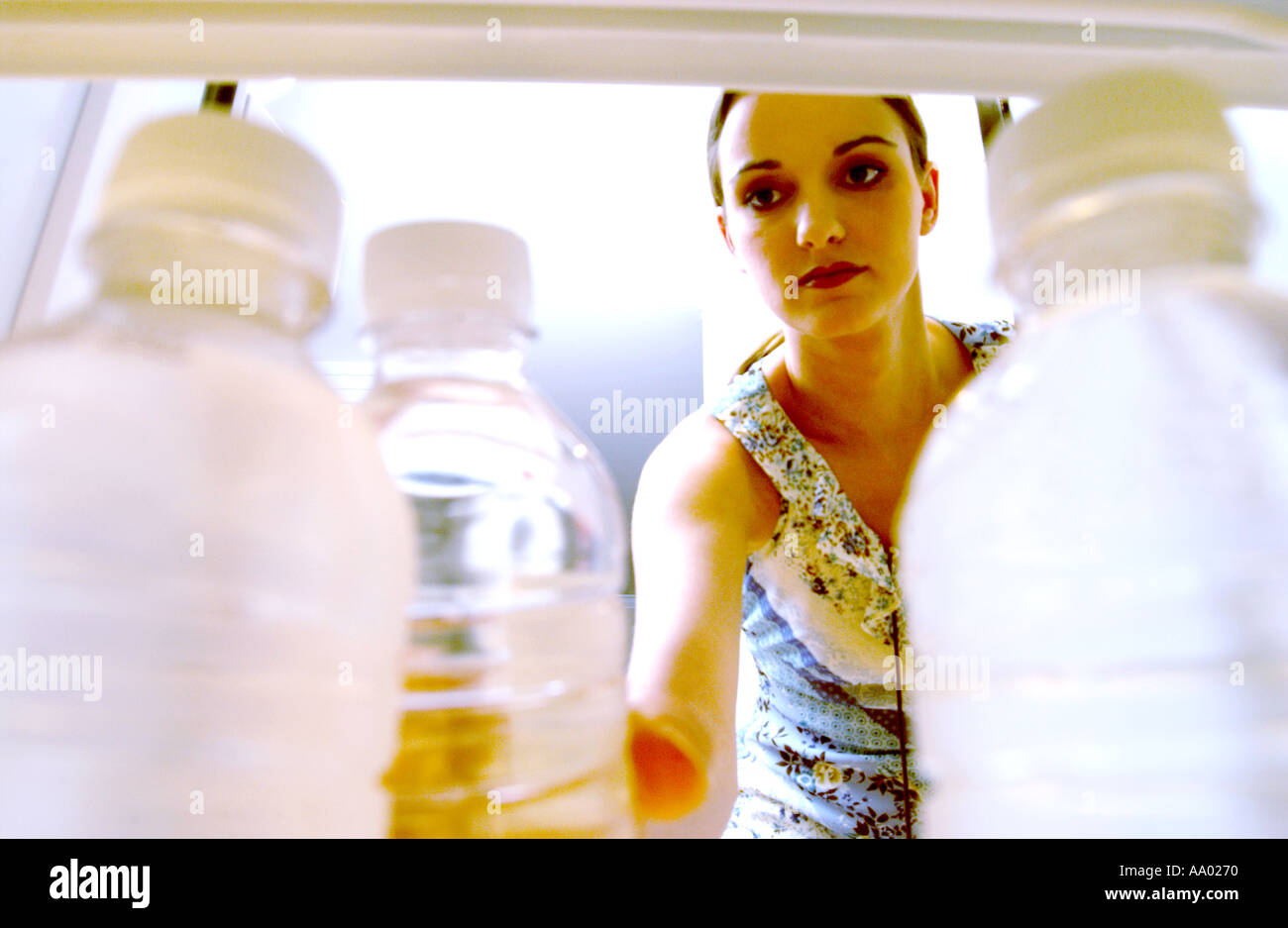 Horizontal color image of an adult female getting a container of ...
