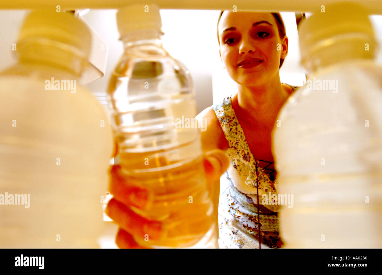 Horizontal color image of an adult female getting a container of ...