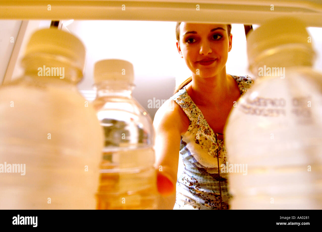 Horizontal color image of an adult female getting a container of ...