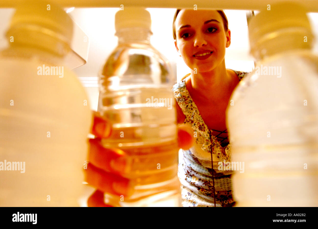 Horizontal color image of an adult female getting a container of ...