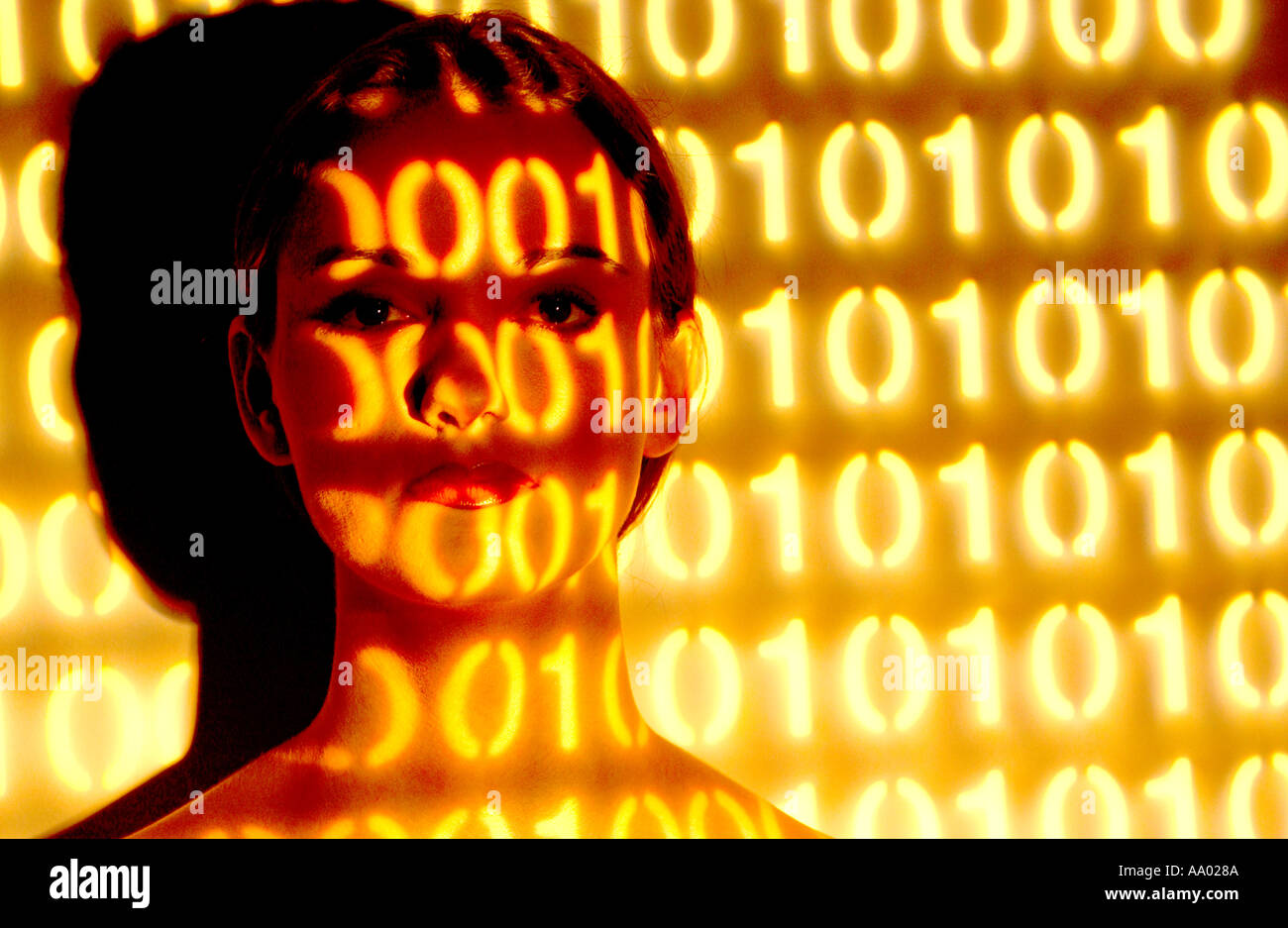 Horizontal color image of an adult female with binary code projected onto her face Stock Photo ...