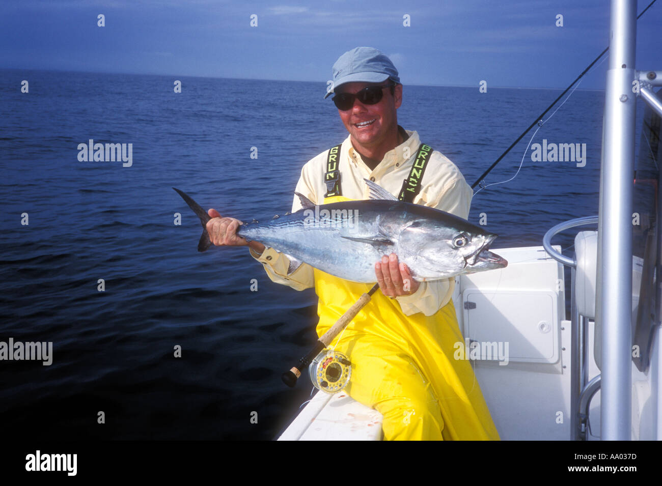 Man with little tunny fish caught while fly fishing off the coast of ...