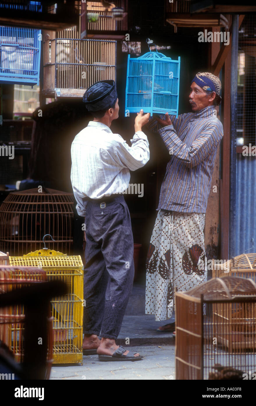 Man selling birds in public bird market Yogyakarta Java Indonesia ...