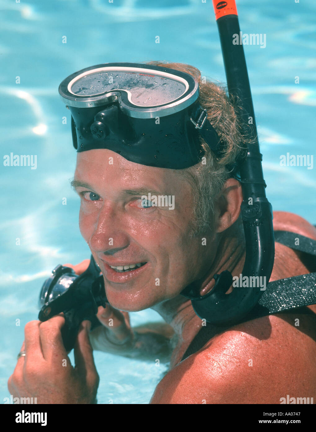 mature man in skin diving gear preparing to enter water Stock Photo - Alamy