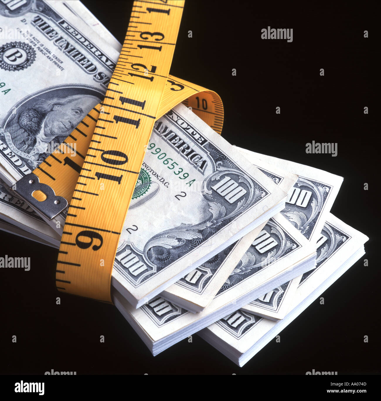 bundles of 100 dollar bills US wrapped with tape measure Stock Photo ...