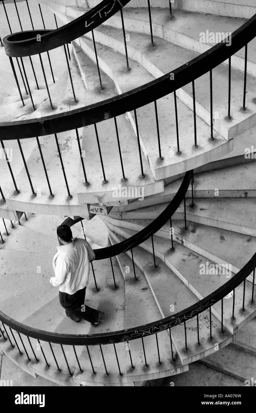 Man descending spiral stairs hi-res stock photography and images - Alamy