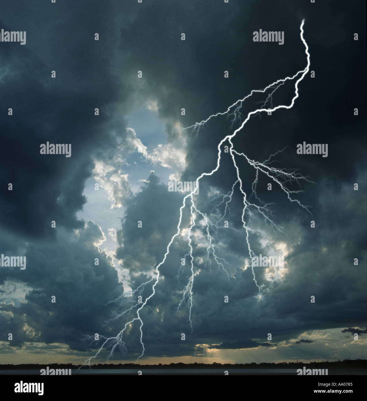 lightning streaks across stormy cloudy sky just before sunset Stock Photo - Alamy