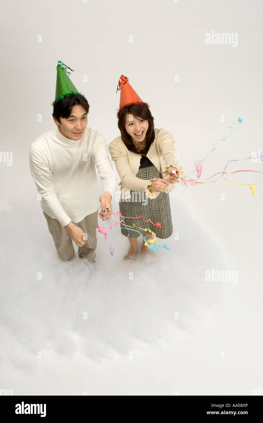 Couple wearing party hats Stock Photo - Alamy