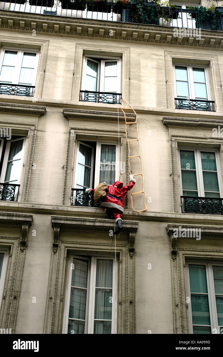 Santa Claus climbing outside of building in Paris France Stock Photo ...