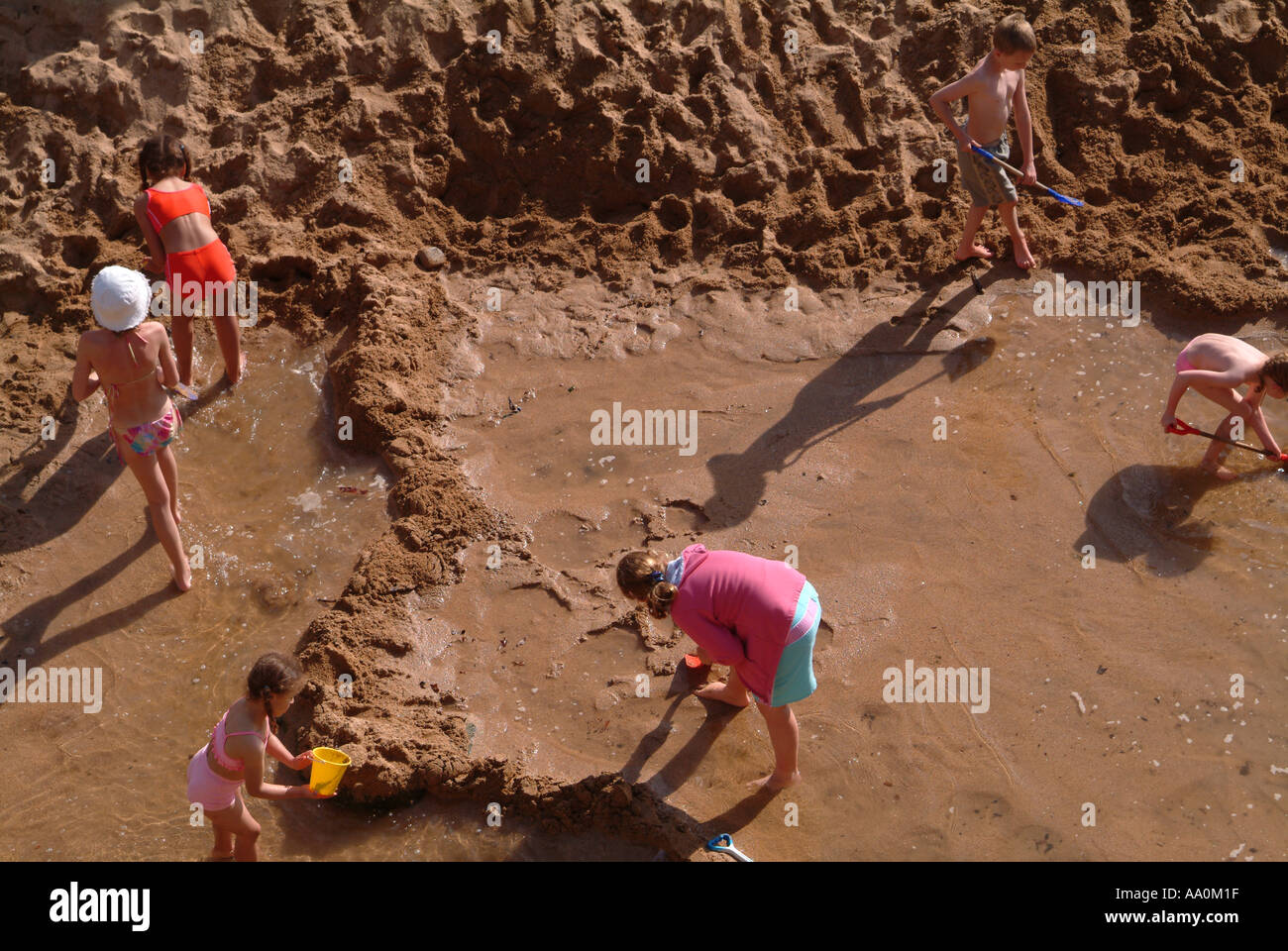 Overhead view of children playing in the sand at the seaside, UK Stock ...