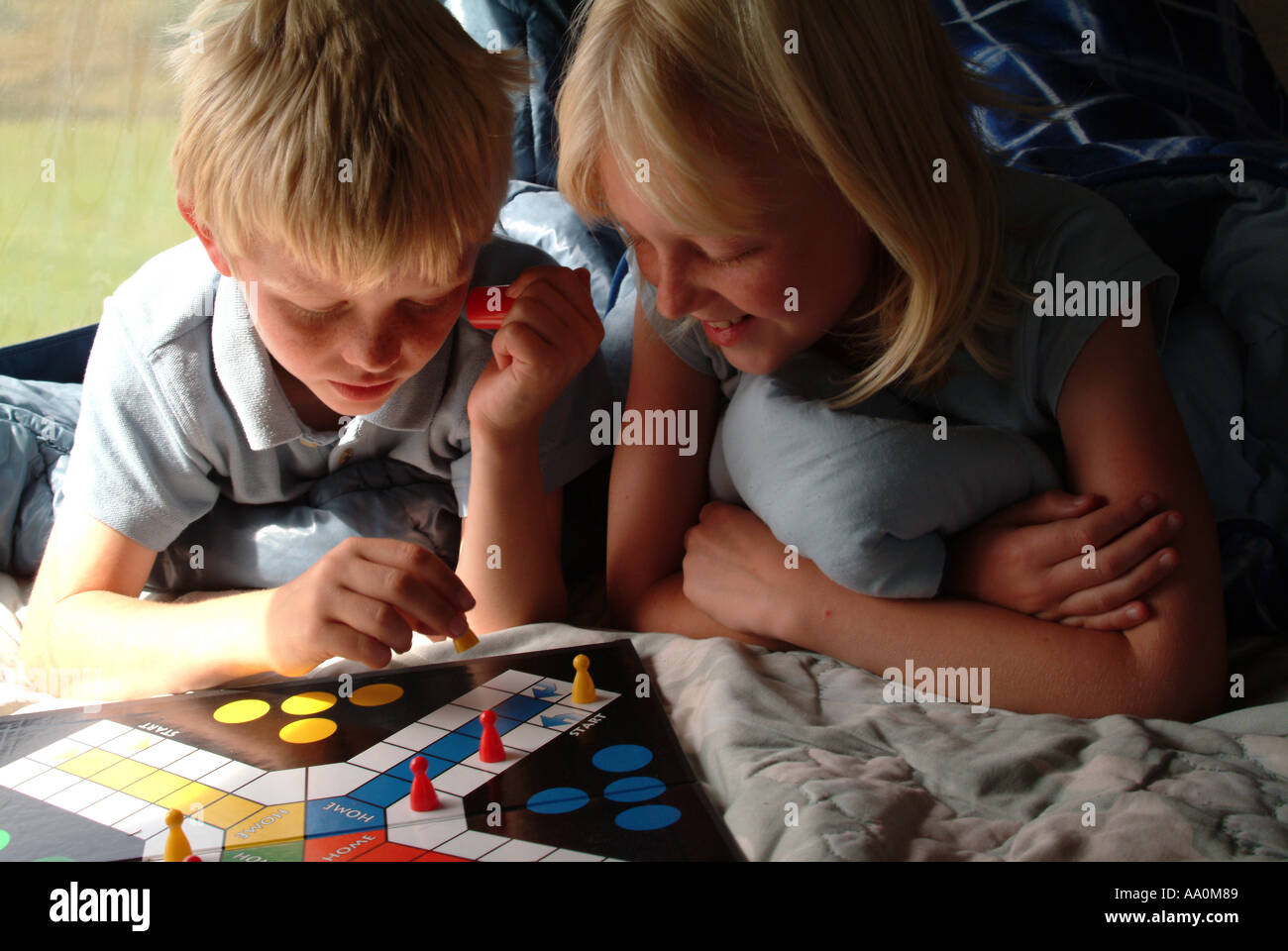 Two children playing a game of Ludo Stock Photo - Alamy