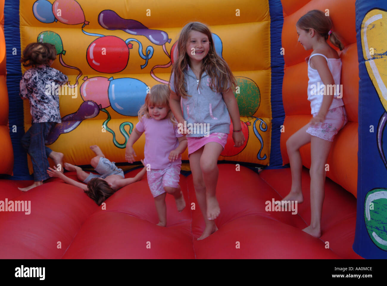 Children jumping on a bouncy castle Stock Photo - Alamy