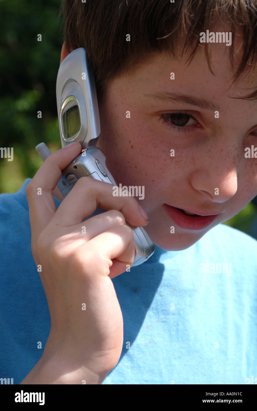 Young boy using a mobile phone Stock Photo - Alamy