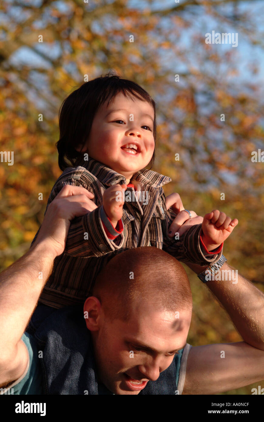 Father giving a child a piggyback ride Stock Photo - Alamy