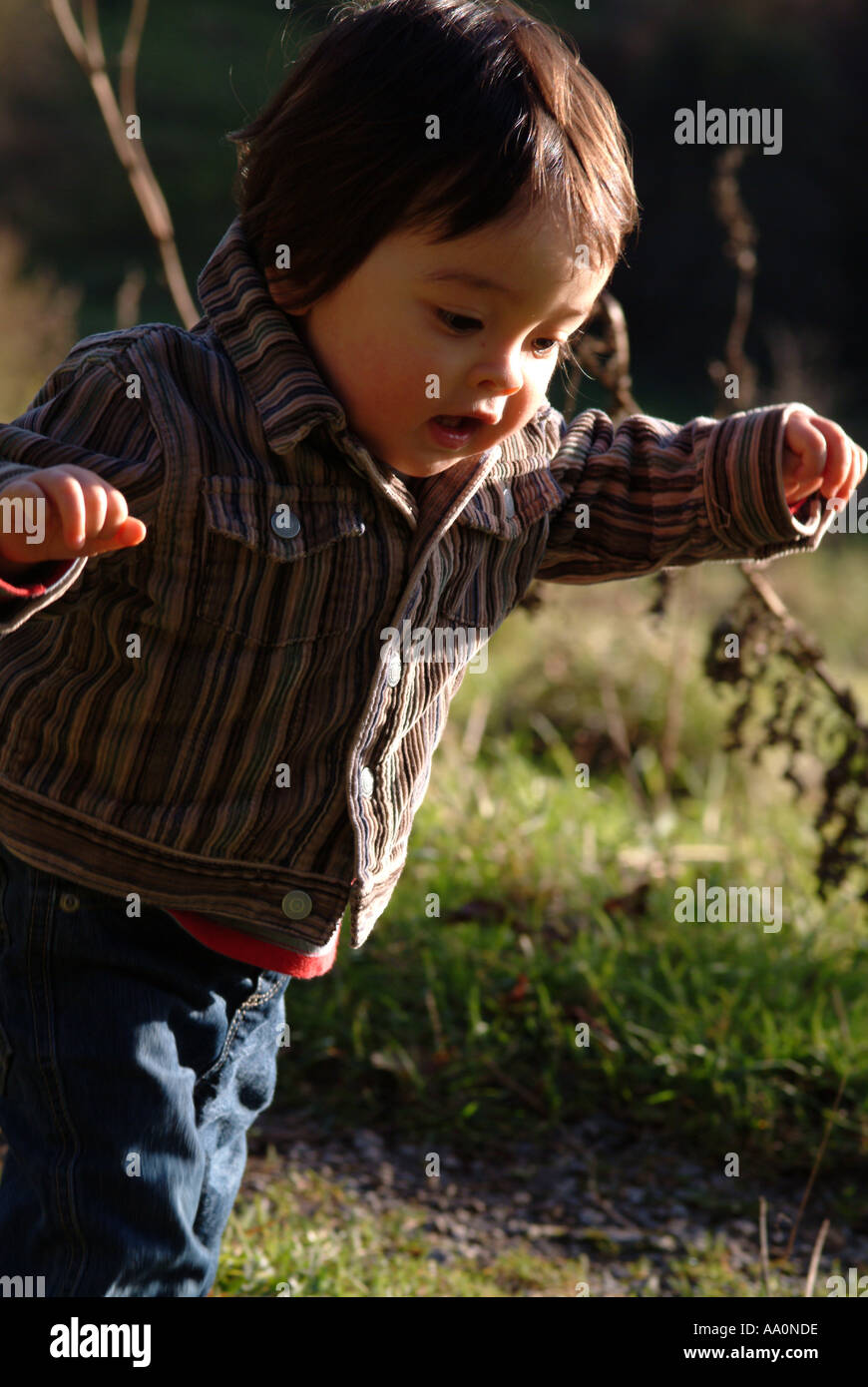 Toddler playing outside Stock Photo - Alamy