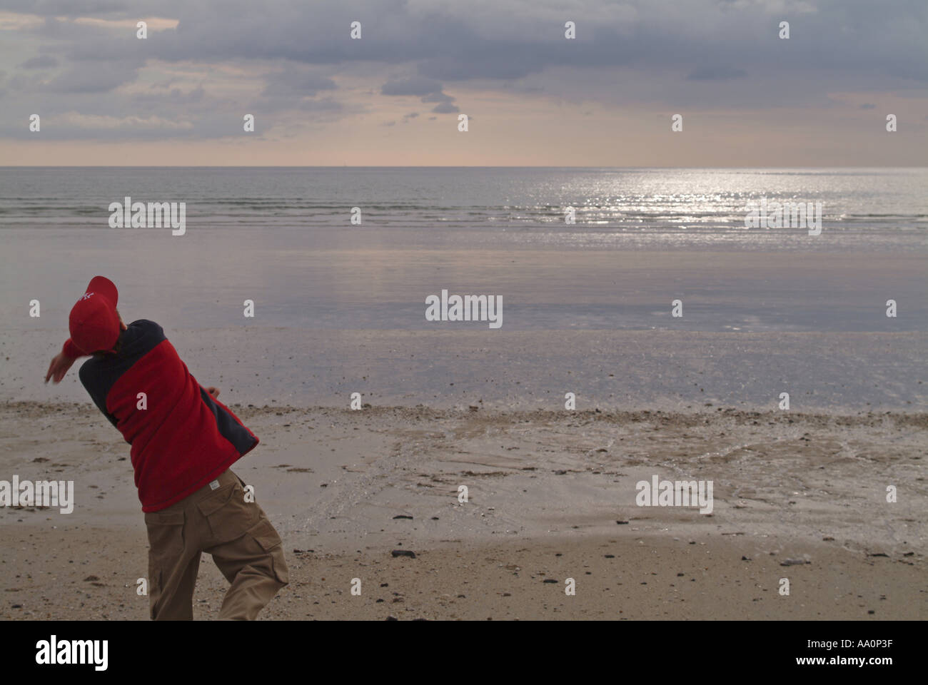 Boy Throwing Pebbles Into The Sea High Resolution Stock Photography and ...