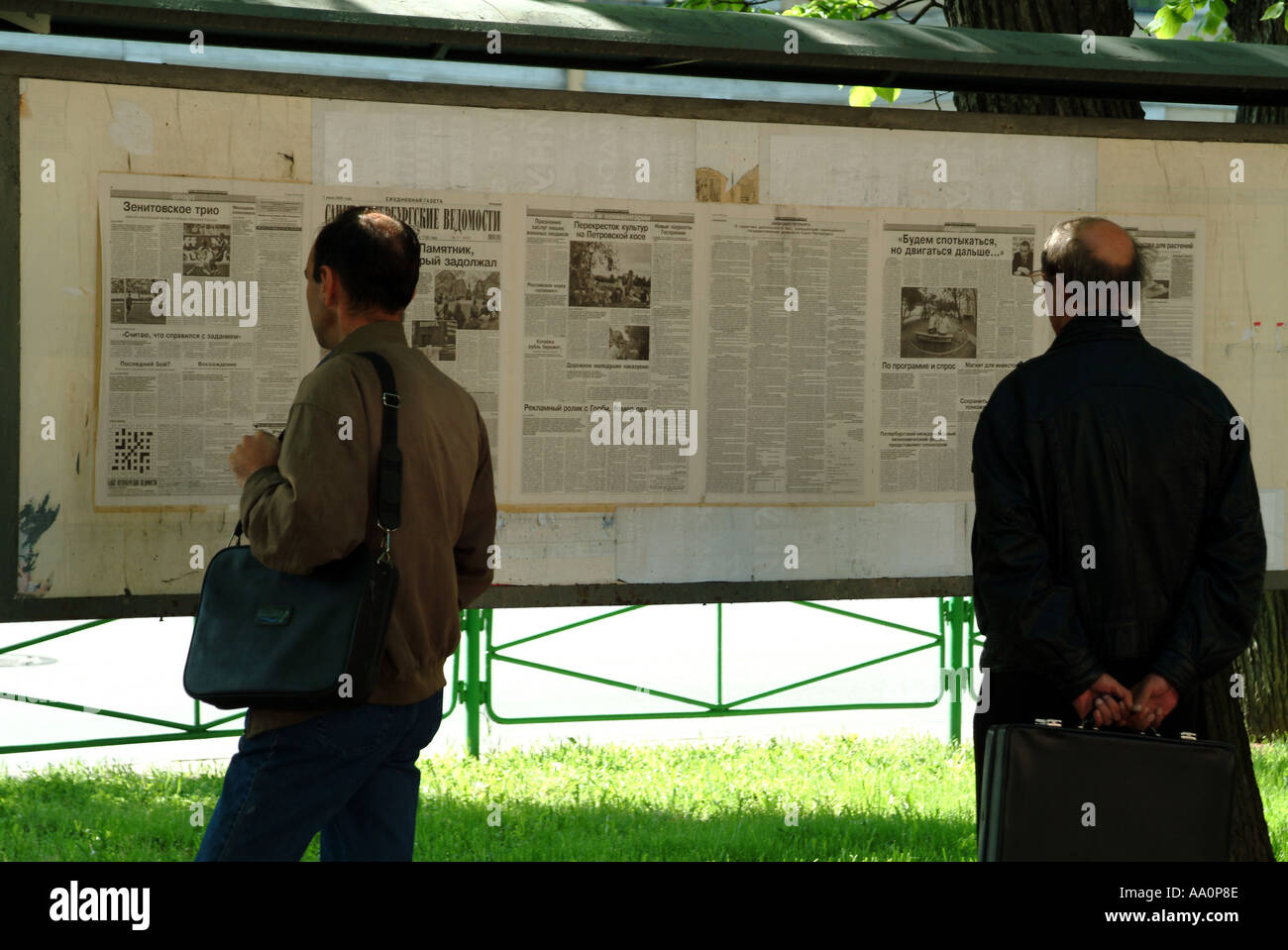 Russian men reading a daily newpaper displayed in a park St Saint ...