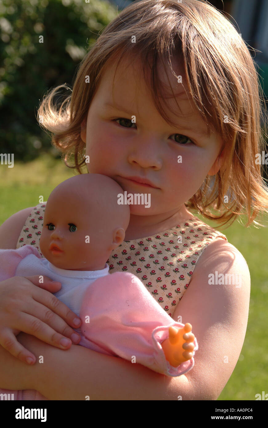 Child hugging her doll hi-res stock photography and images - Alamy