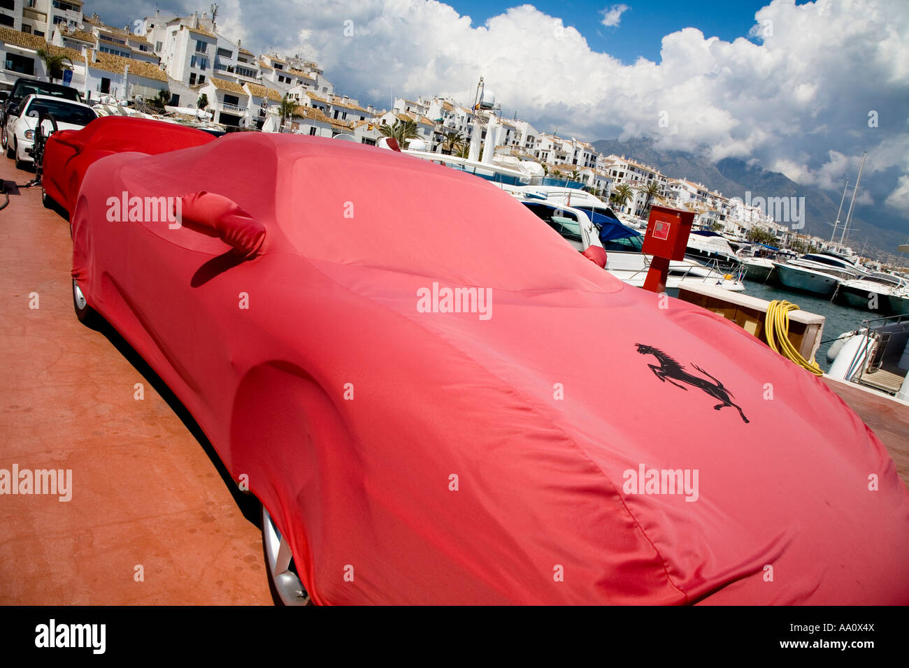 Covered Ferrari on the dockside at Puerto Banus Marbella Spain Stock ...