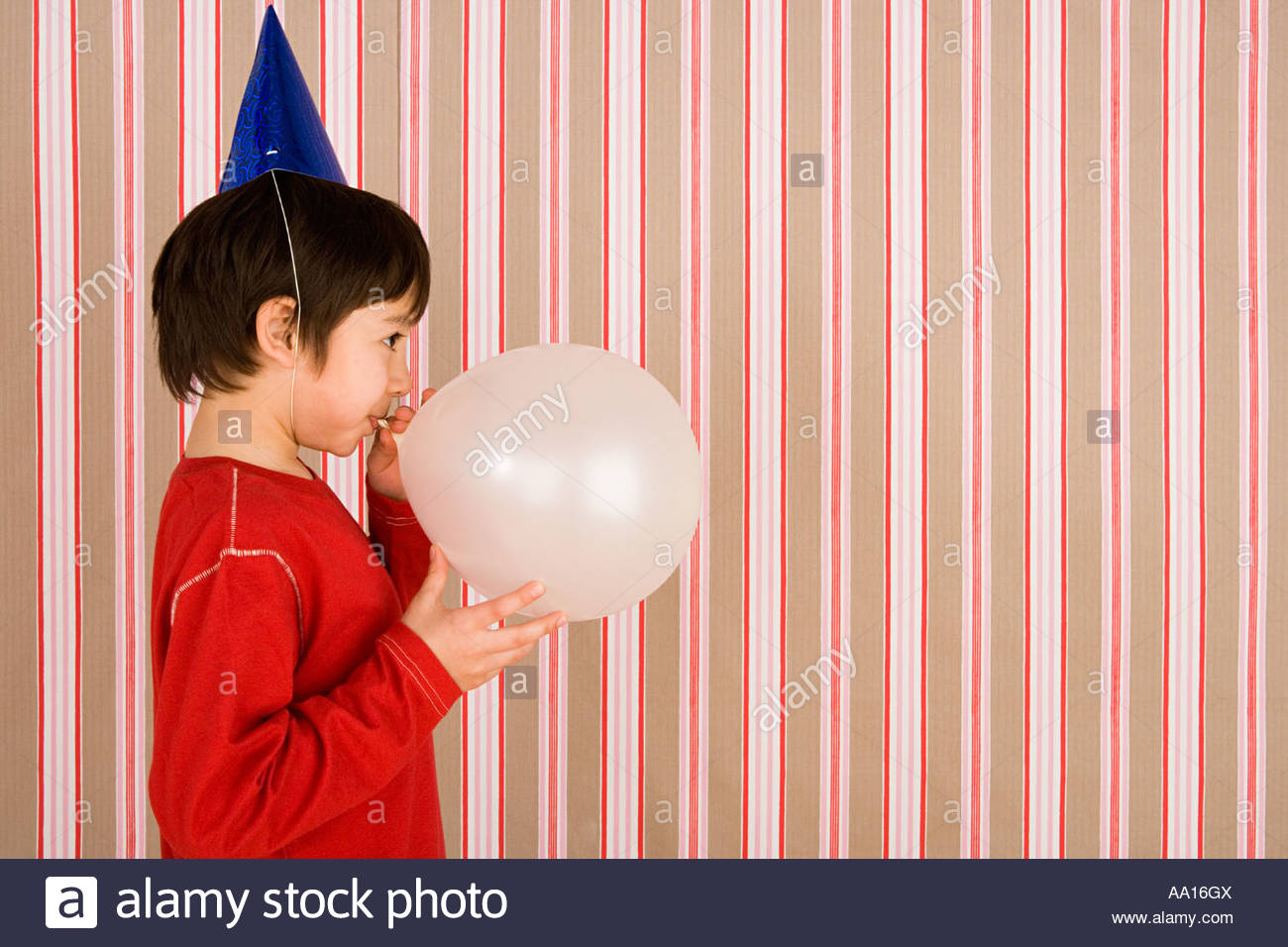 Boy Blowing Up Balloon Stock Photos & Boy Blowing Up Balloon Stock Images - Alamy