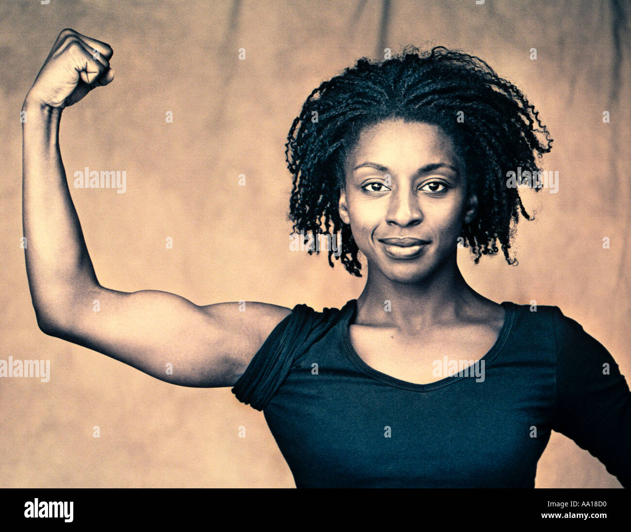 African American woman flexing her bicep muscle Stock Photo - Alamy