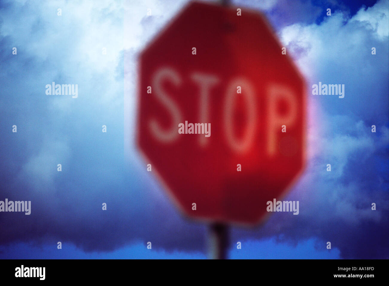 Stop sign out of focus with storm clouds in background Stock Photo - Alamy