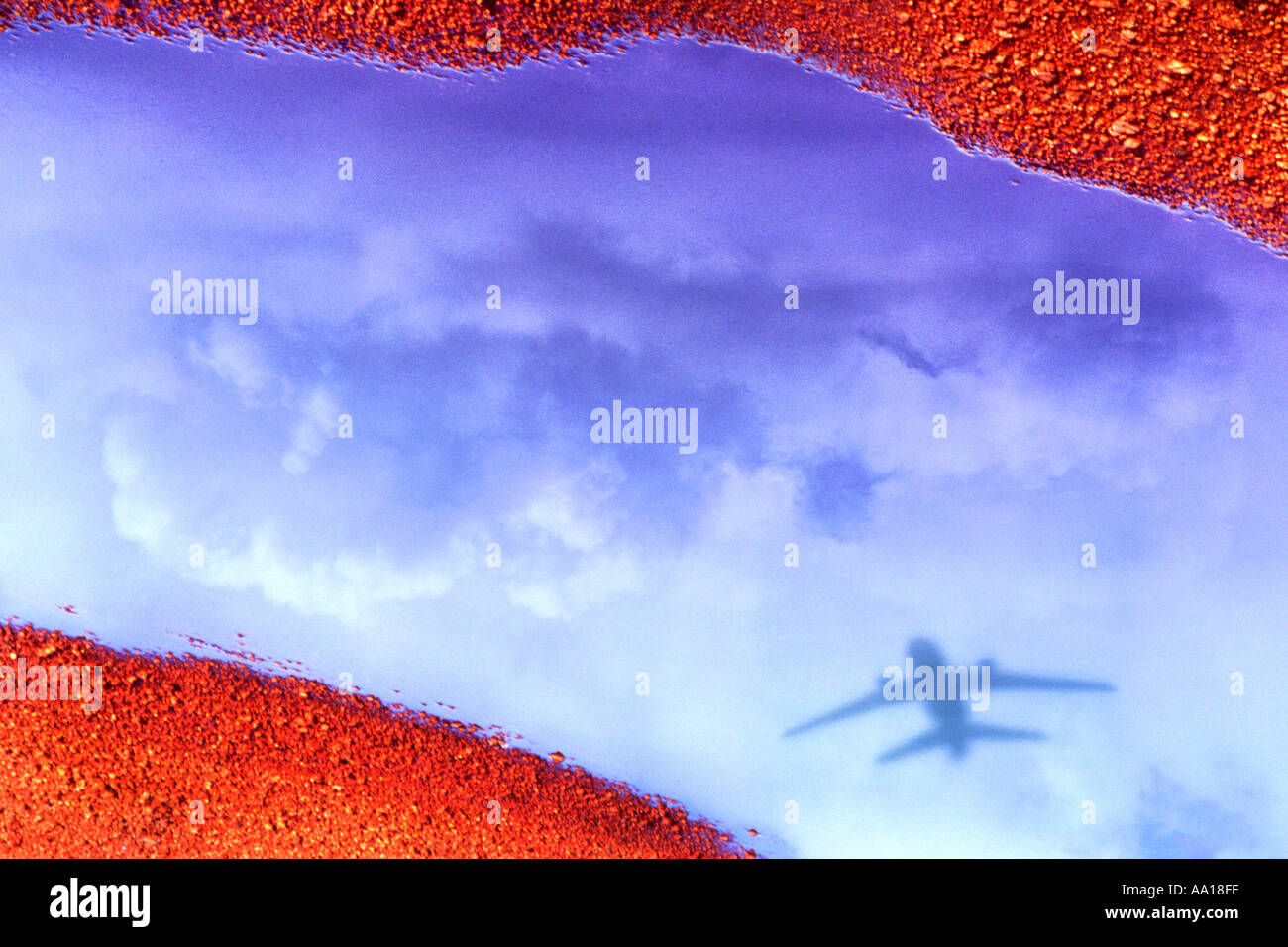Aerial view of clouds and shadow of airplane reflecting on smooth ...